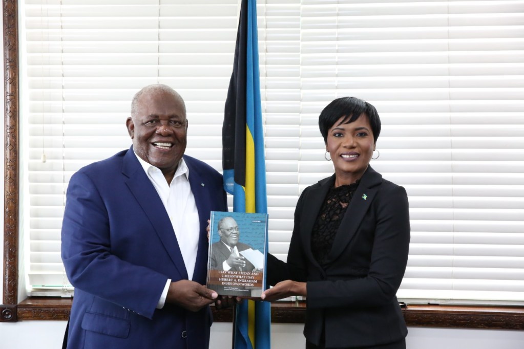 Former Prime Minister Ingraham presents a copy of his new book to GB ...