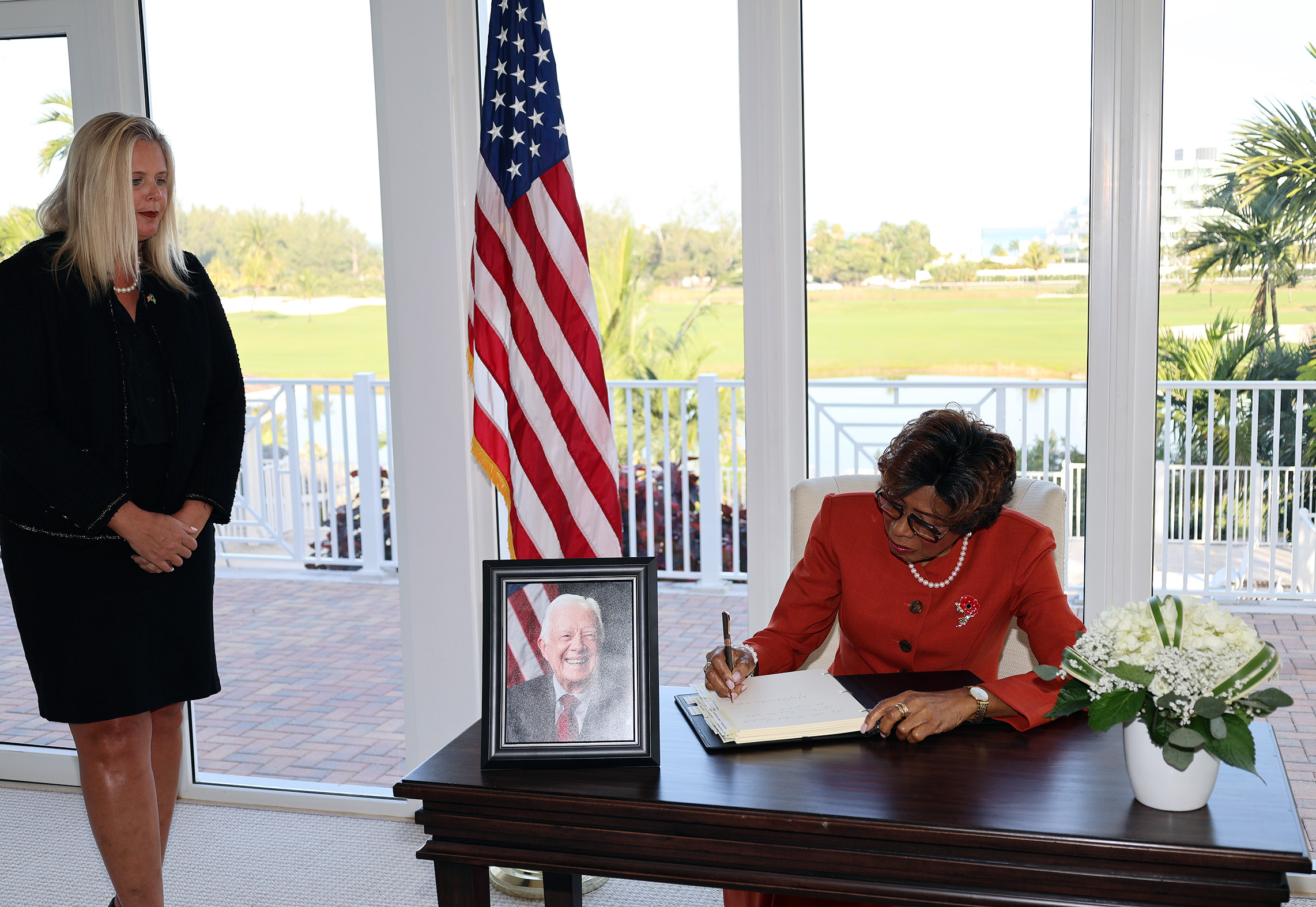 Governor General Dame Cynthia Pratt signs the Book of Condolence for ...
