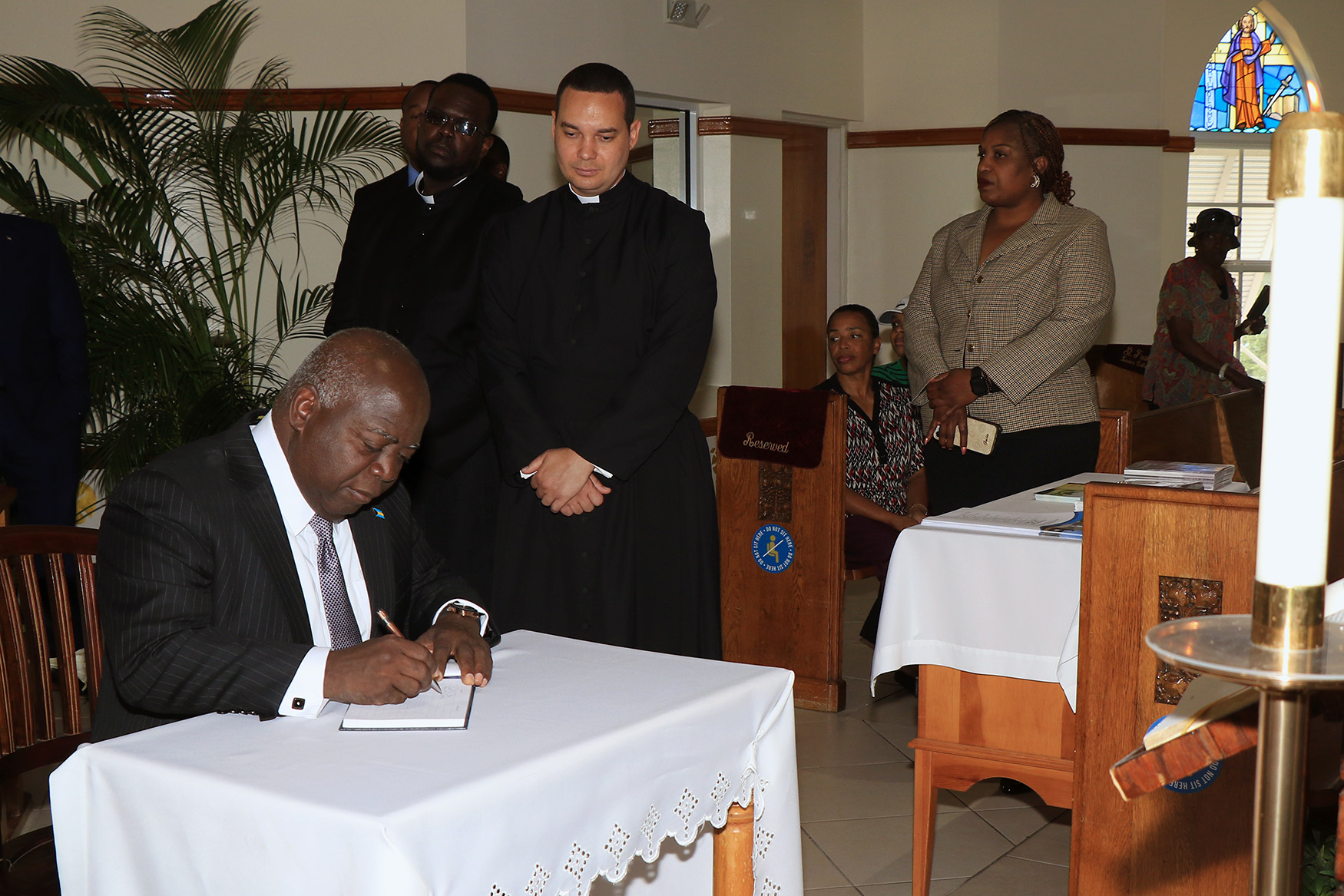 Prime Minister Philip Davis signs the Book of Condolence on the passing ...